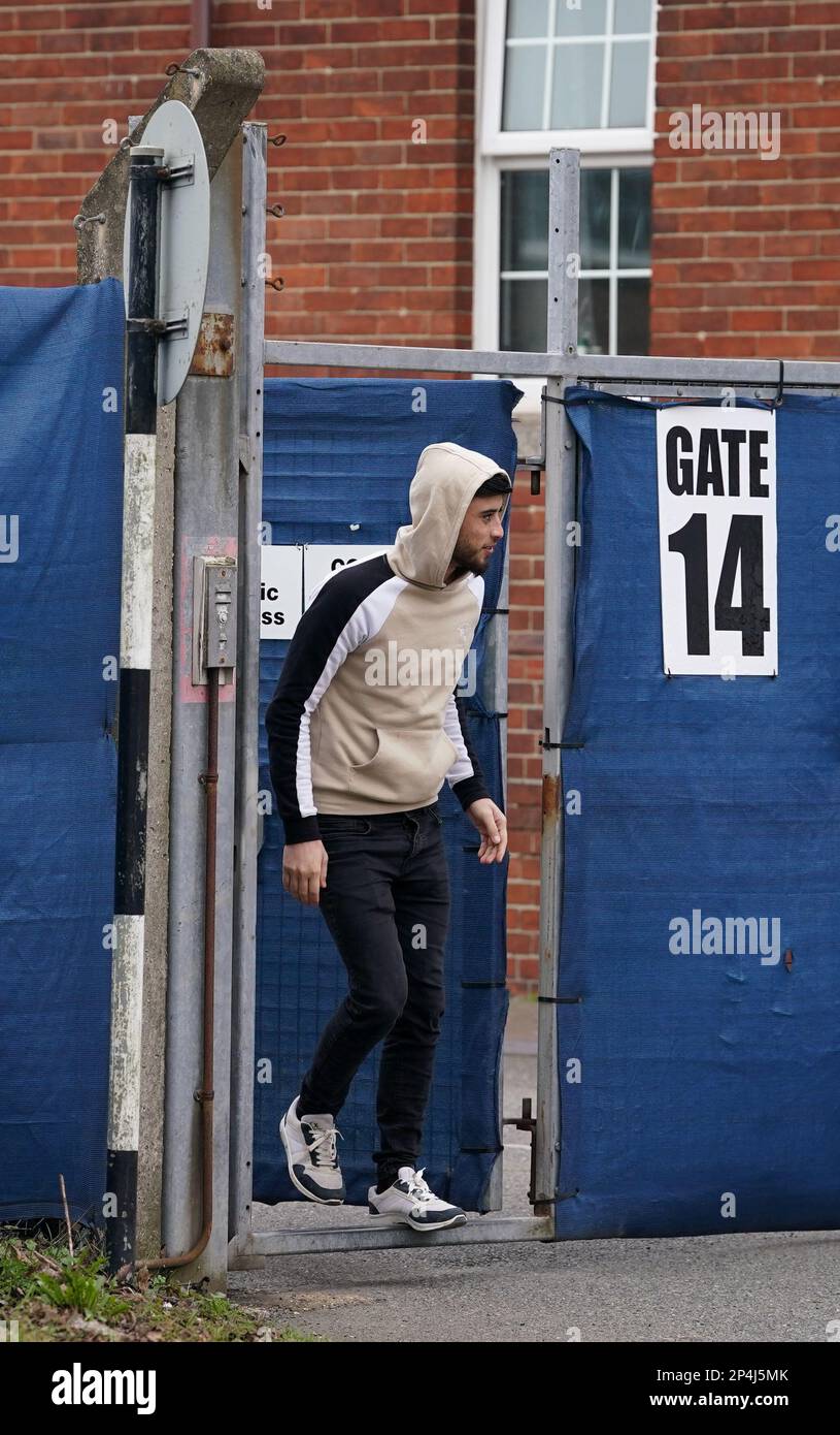 Migrants housed at Napier Barracks in Folkestone, Kent, leave through ...