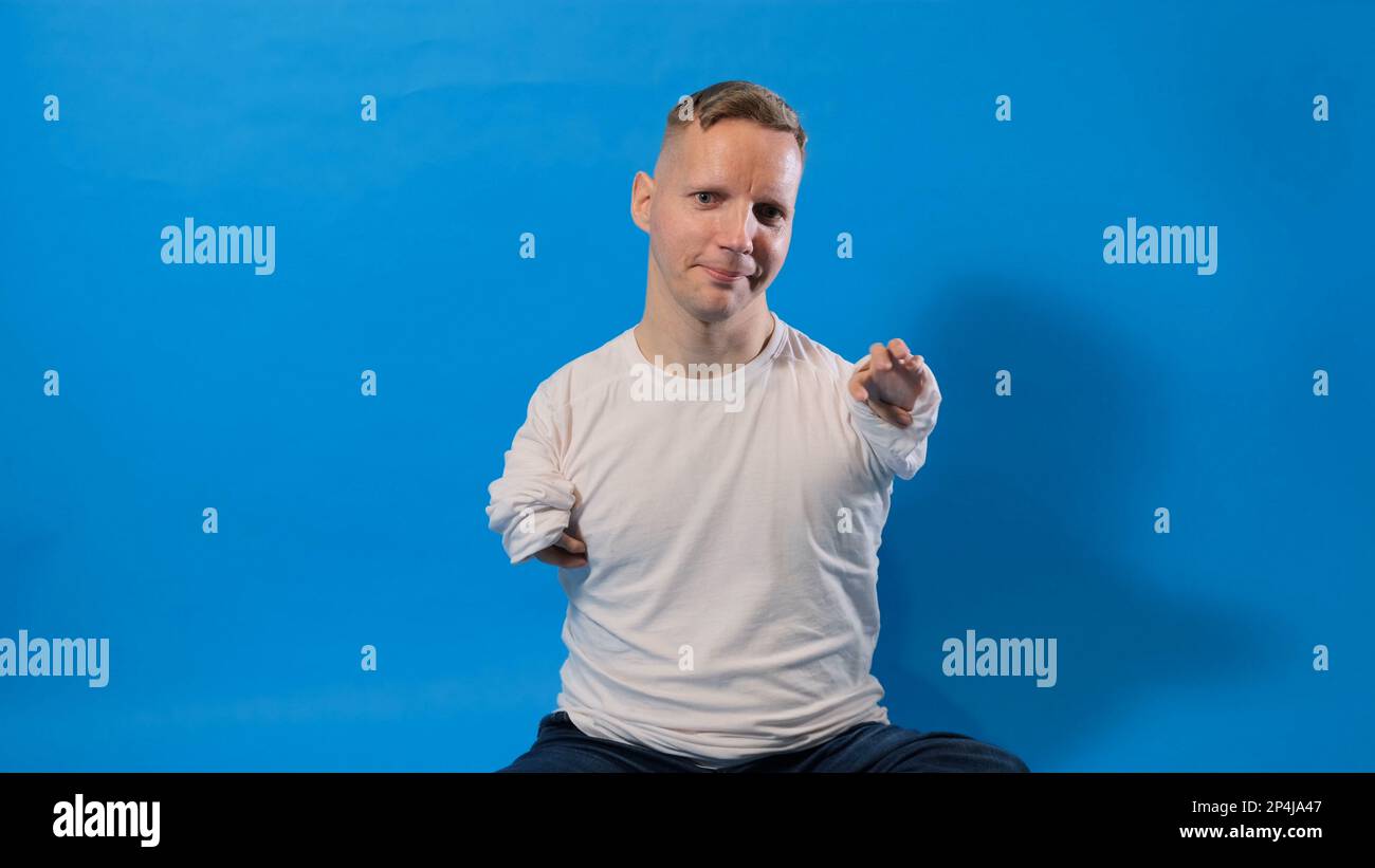Hi Portrait of a friendly, joyful man with disabilities in a casual ...