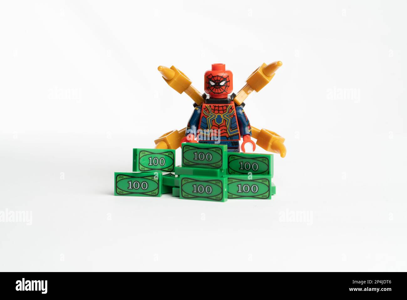 A Lego Minifigure of Iron spiderman, standing in front of 100 dollar ...