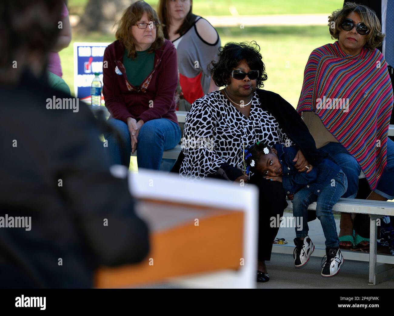 Asia Johnson, 4, rests her head on her grandmother Kay Washington's lap ...