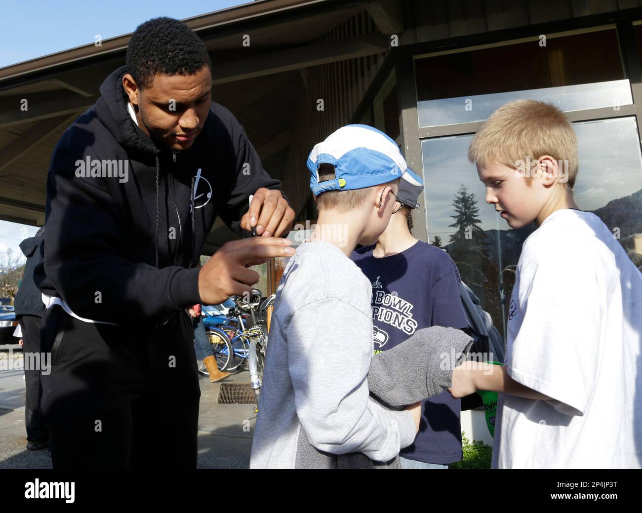 Seattle Seahawks linebacker Malcolm Smith, left, signs the shirt of ...