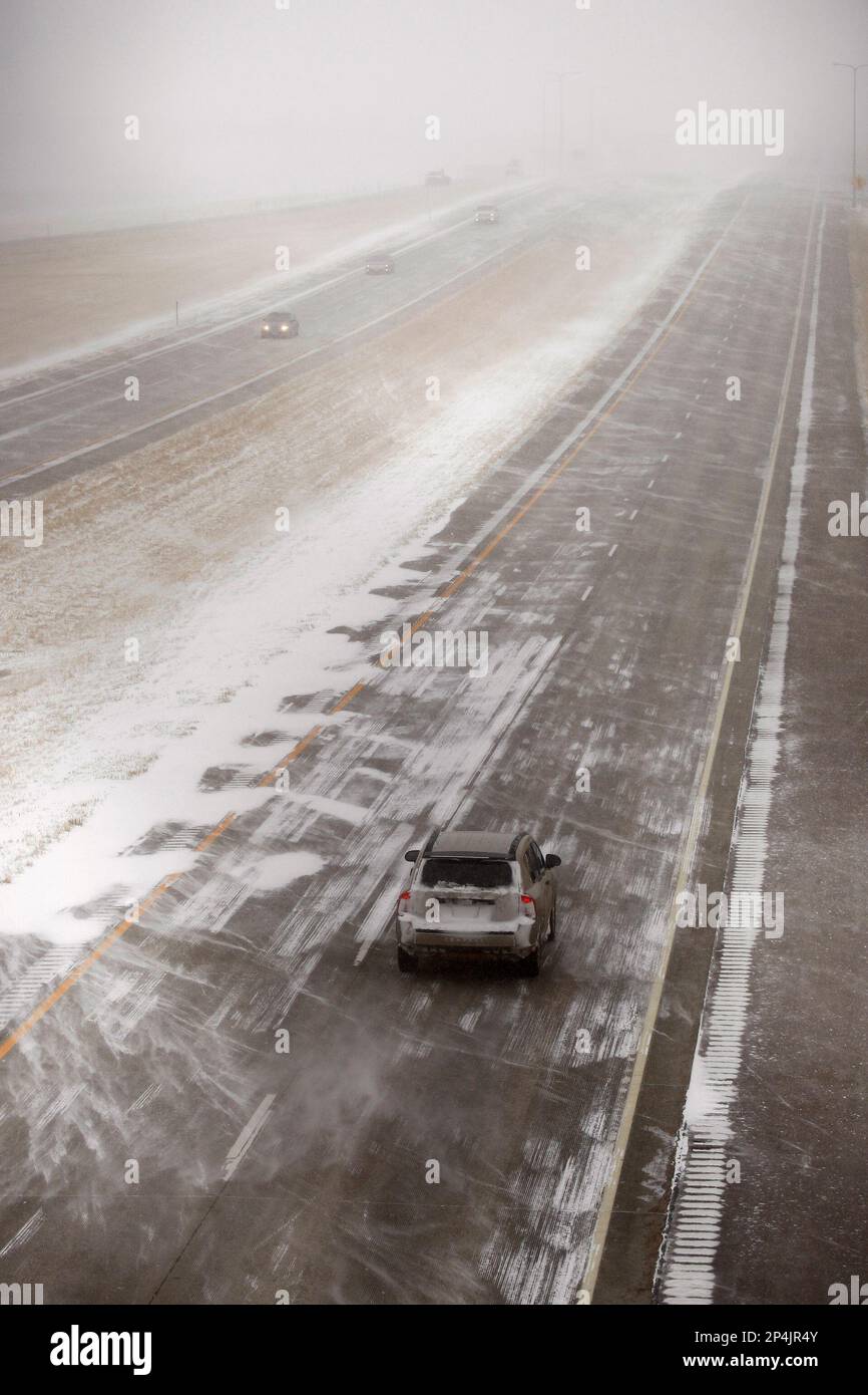 Cars drive along Interstate 90 near Black Hawk as a spring storm blasts ...