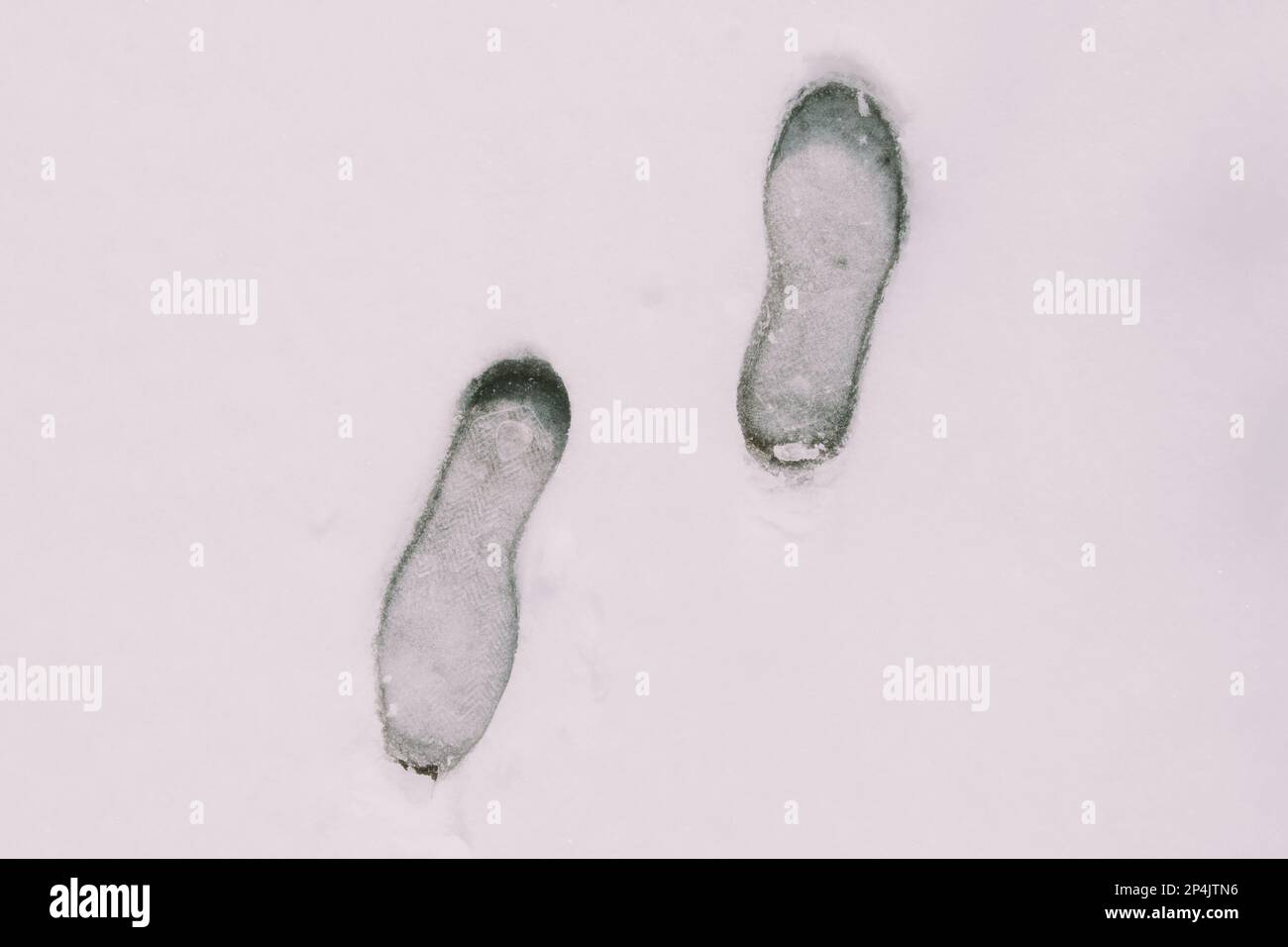 Foot marks in the snow in a garden Stock Photo - Alamy