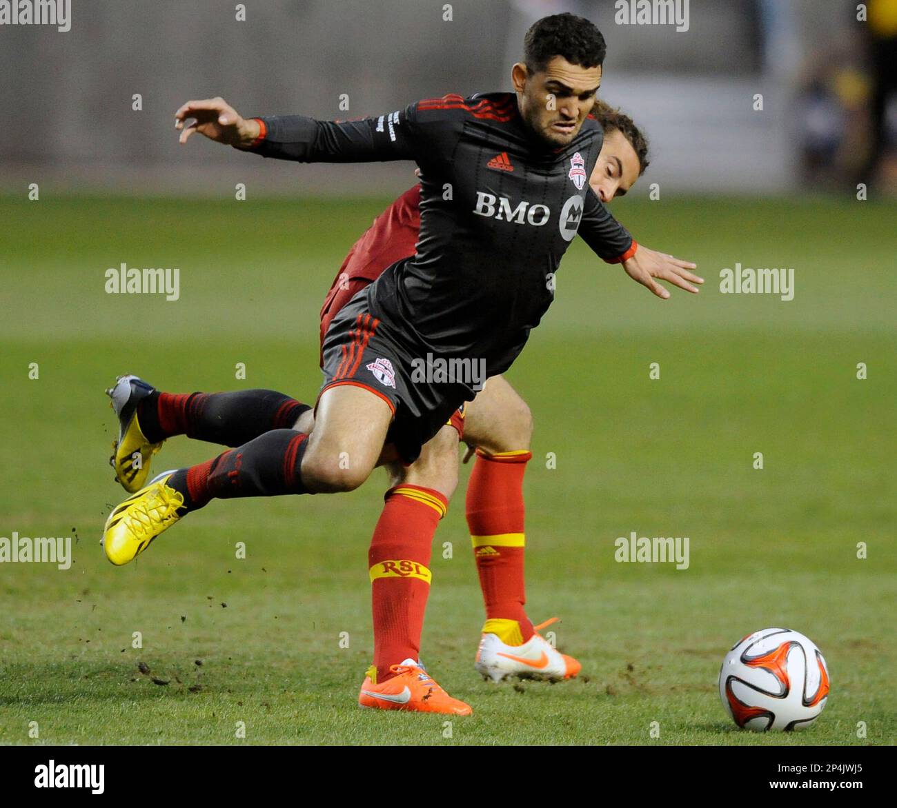 Real Salt Lake midfielder Kyle Beckerman, rear, upends Toronto FC ...