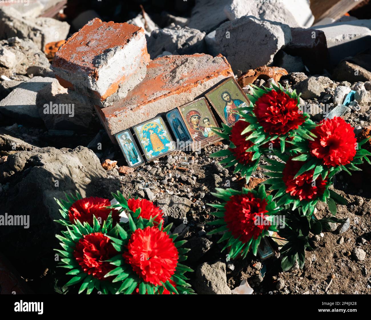 Icons and artificial flowers in memory of the city's dead. Memorial ...