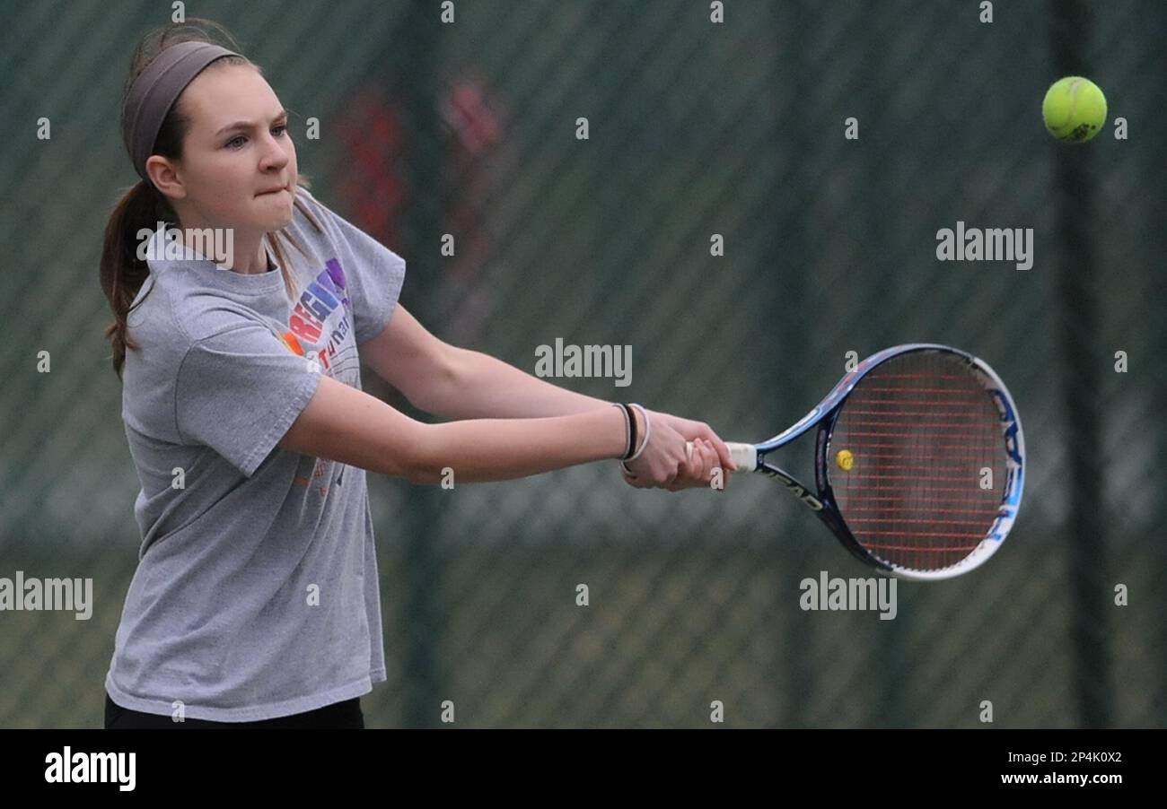Russell's Maci Ferguson hits a volley during a doubles match in the pre ...