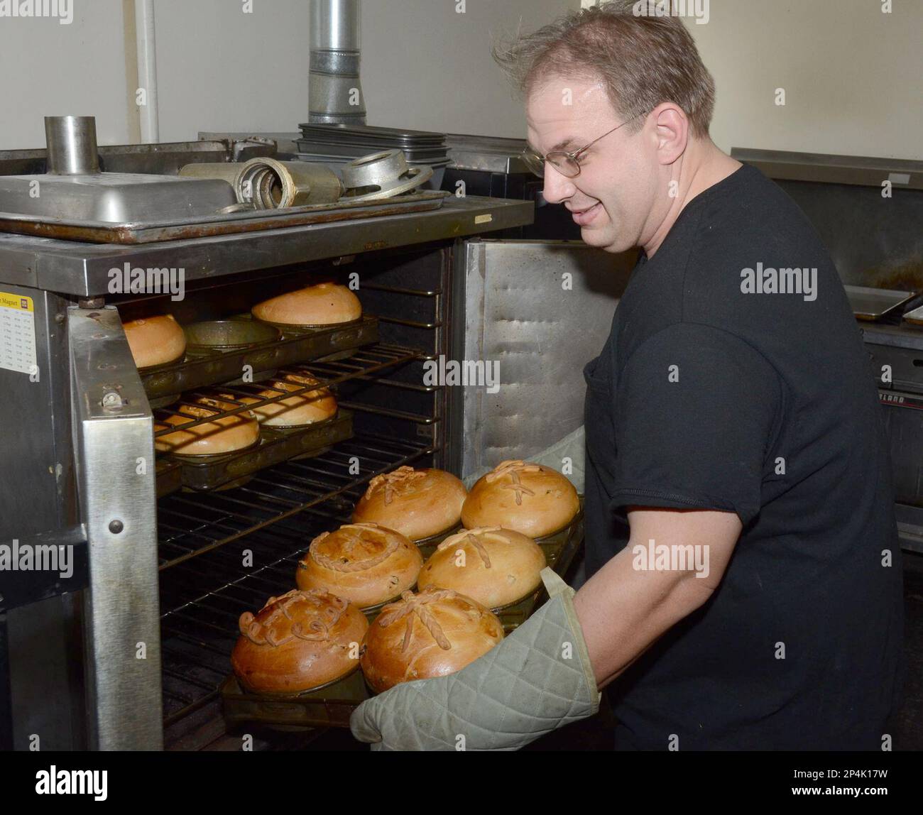 Peter Smetana Jr. removes Paska bread from an oven Thursday, March 27 ...