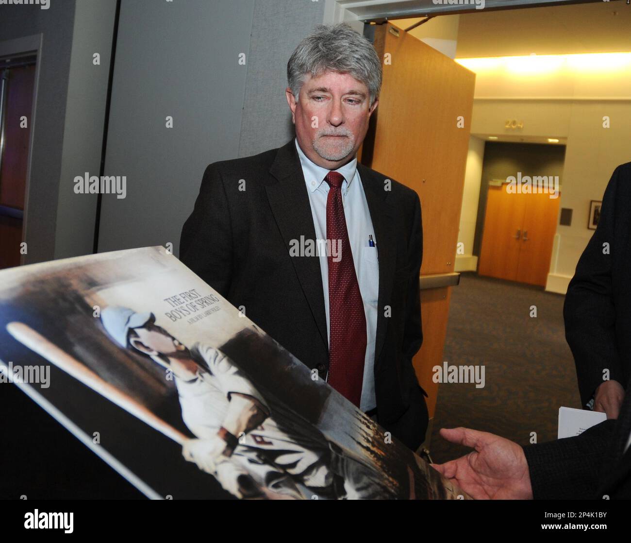 Filmmaker Larry Foley of Fayetteville, Ark., looks over a poster for ...