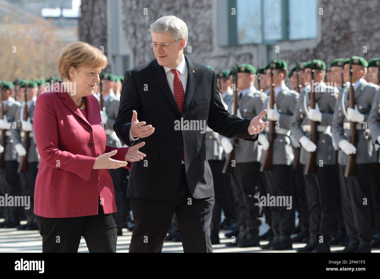 Prime Minister Stephen Harper walks with German Chancellor Angela ...