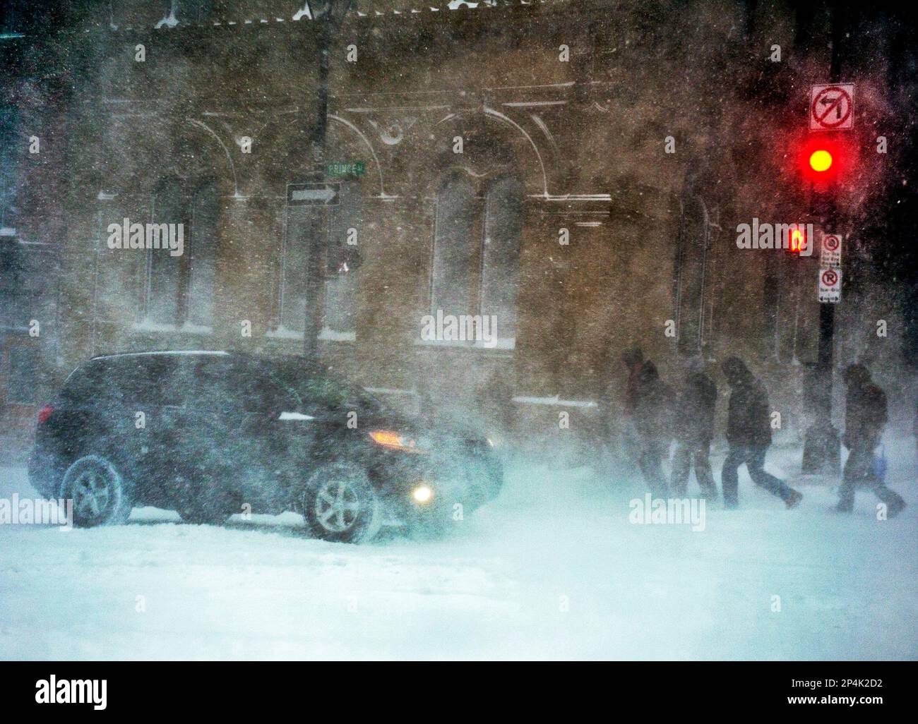 Pedestrians battles the high winds and blowing snow during a spring ...