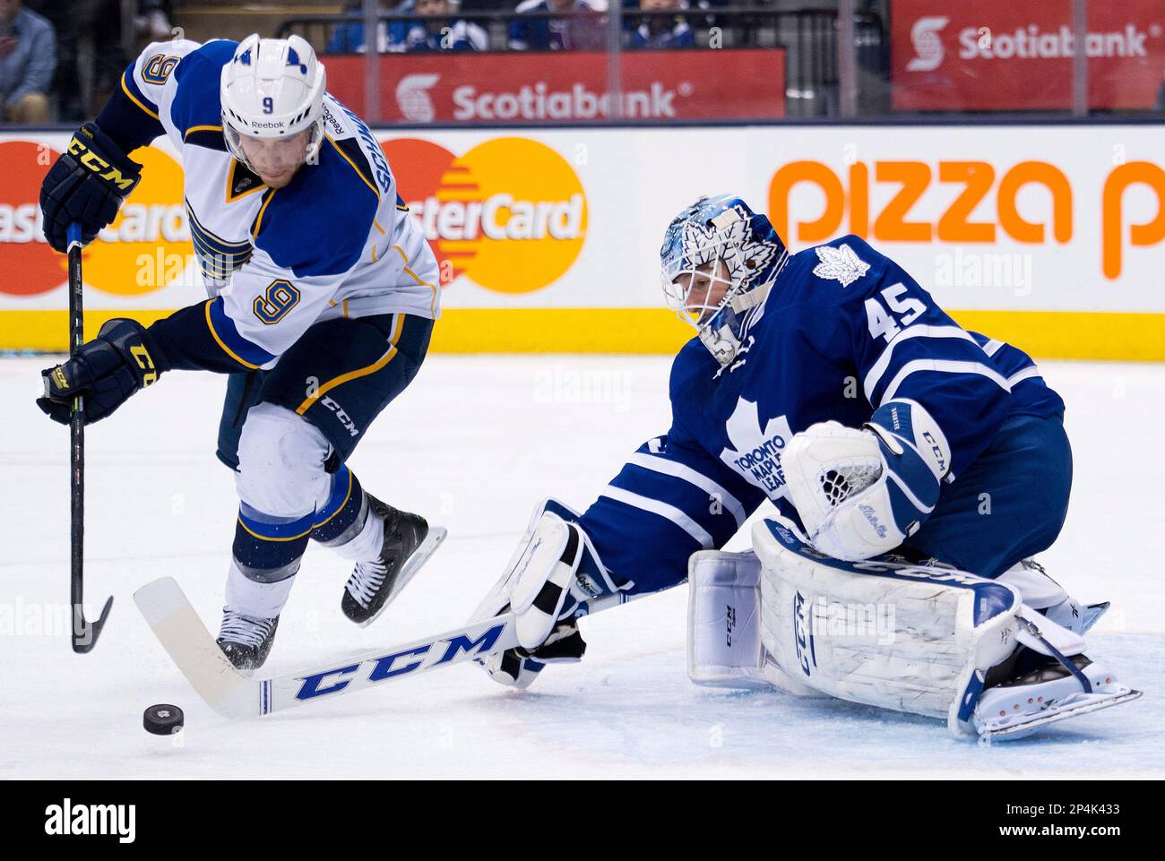 Toronto Maple Leafs goalie Jonathan Bernier poke checks St. Louis Blues ...