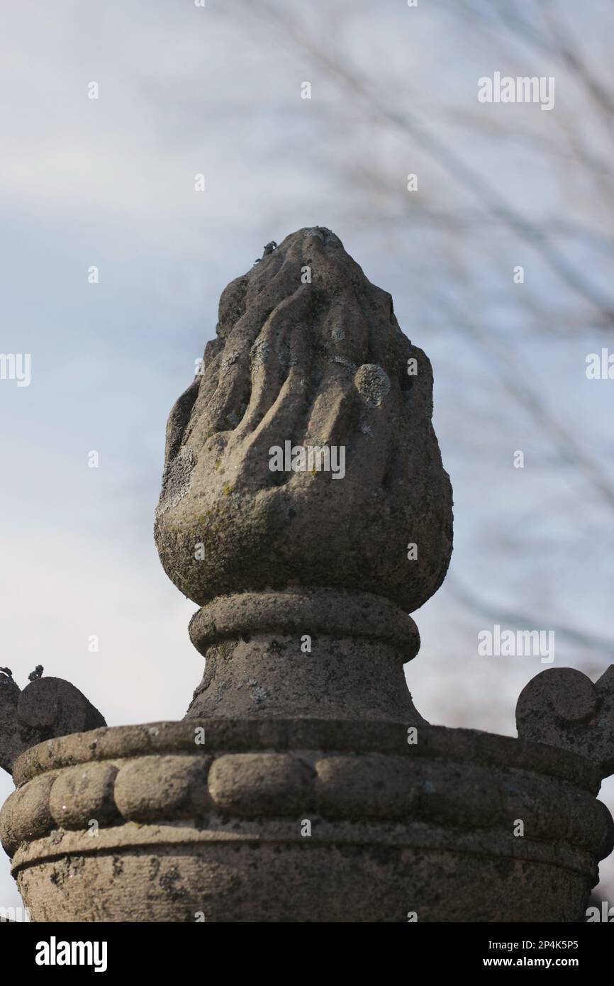 A flaming torch carved into natural stone Stock Photo - Alamy