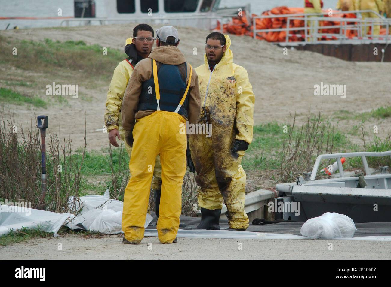 Heavy fuel oil soils the protective suits worn by clean up workers ...