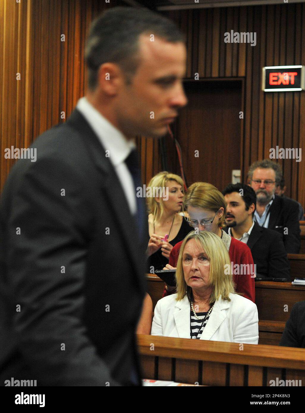 Oscar Pistorius, left, walks past June Steenkamp, right, the mother of ...