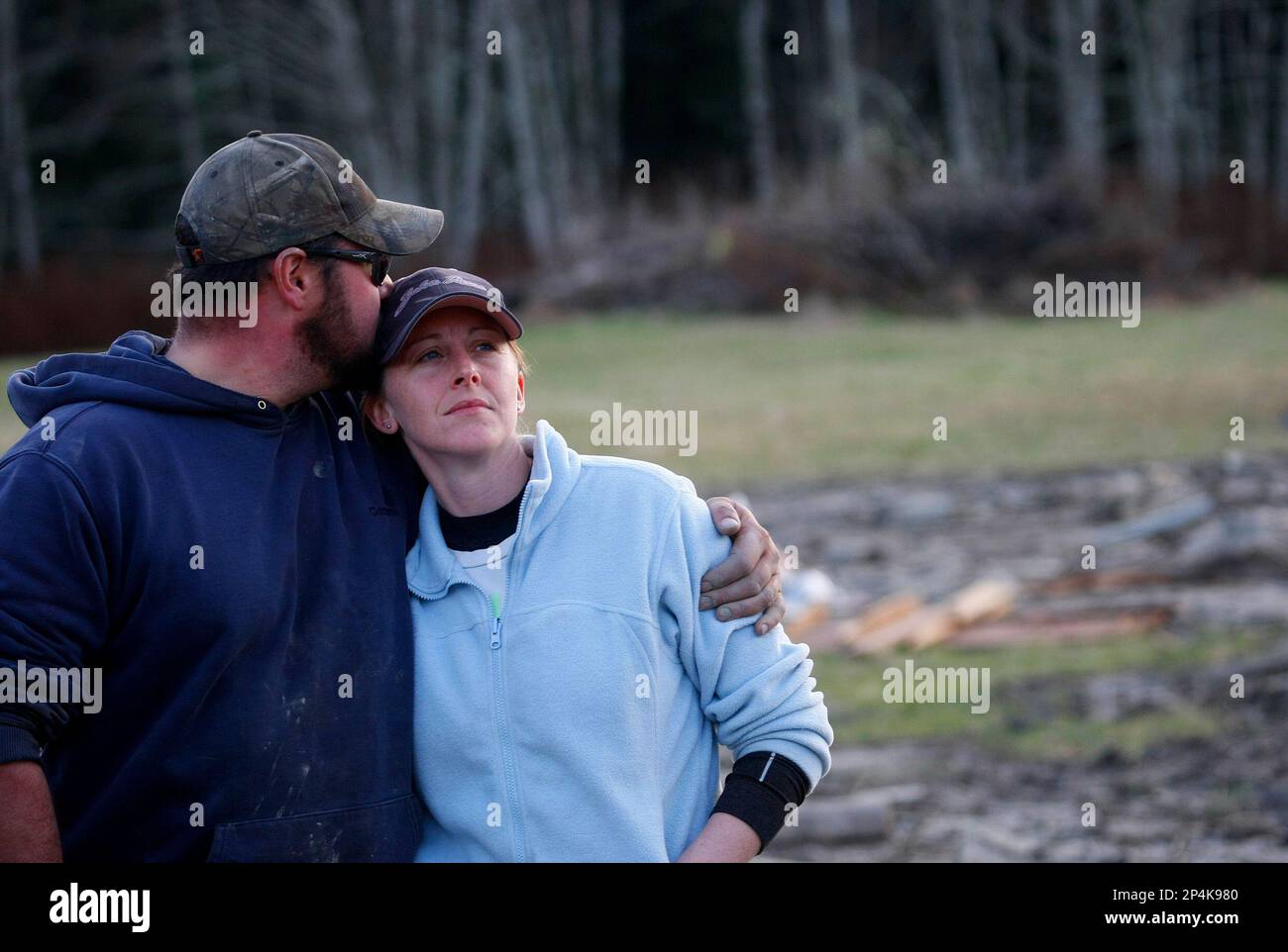Volunteers Frank and Rhonda Cook watch as the final body they recovered ...