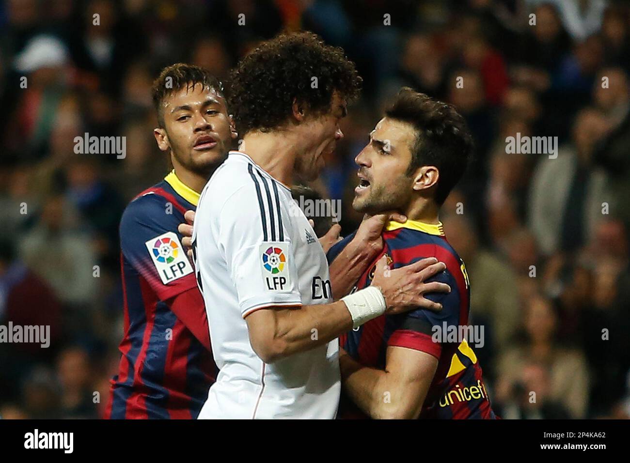 Real's Pepe, centre, reacts with Barcelona's Cesc Fabregas, centre ...