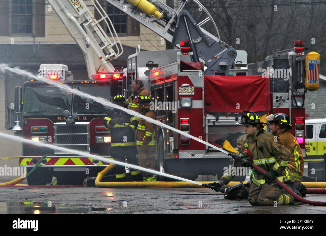 Firefighters from several area fire departments work to bring a fire at ...