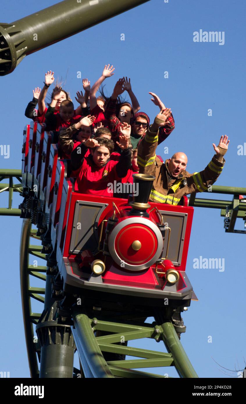 Visitors enjoy the new FireChaser Express roller coaster to kick off ...
