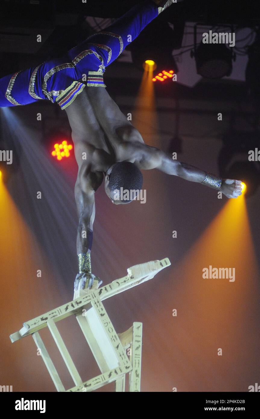 An acrobat balances on chairs during the "Mother Africa" show on ...