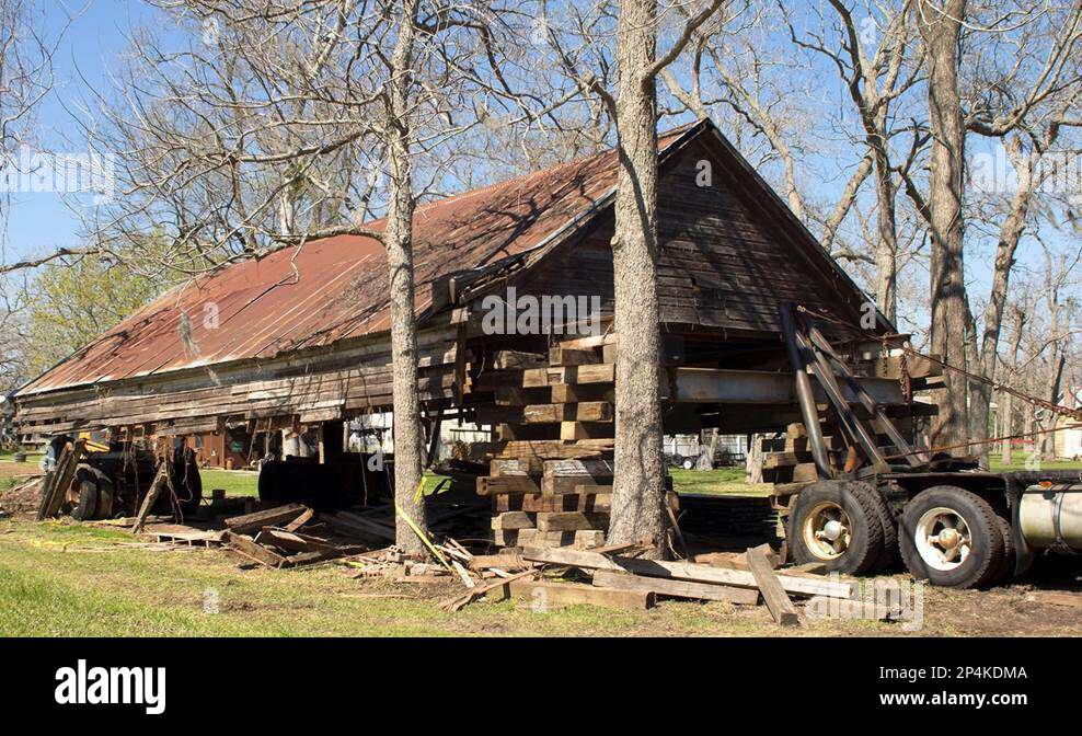 A 25-foot-wide, 50-foot-long wooden rectangle building that faces the ...