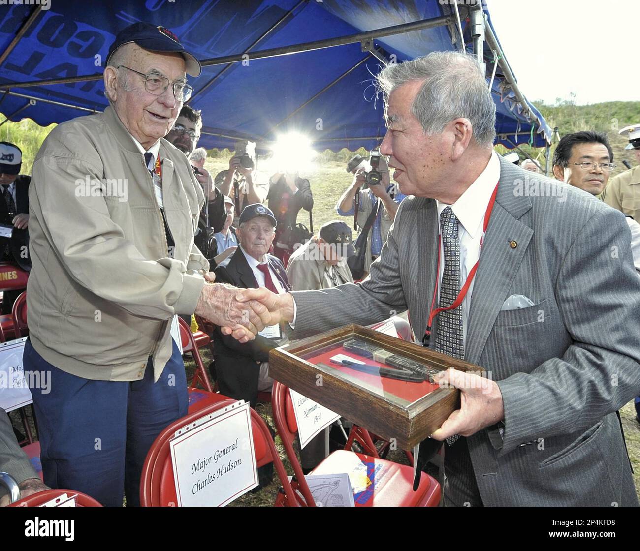 Zenichi Higuchi (R) receives a razor on his father Mitsuru Higuchi, who ...
