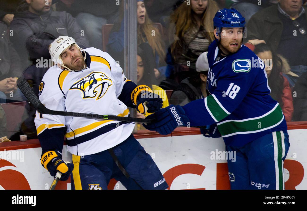 Nashville Predators' Eric Nystrom, left, is checked by Vancouver ...