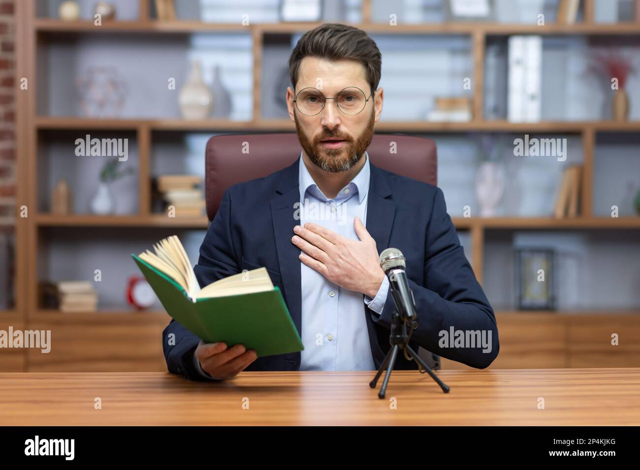 Senior mature pastor reading bible book online, man looking at camera ...