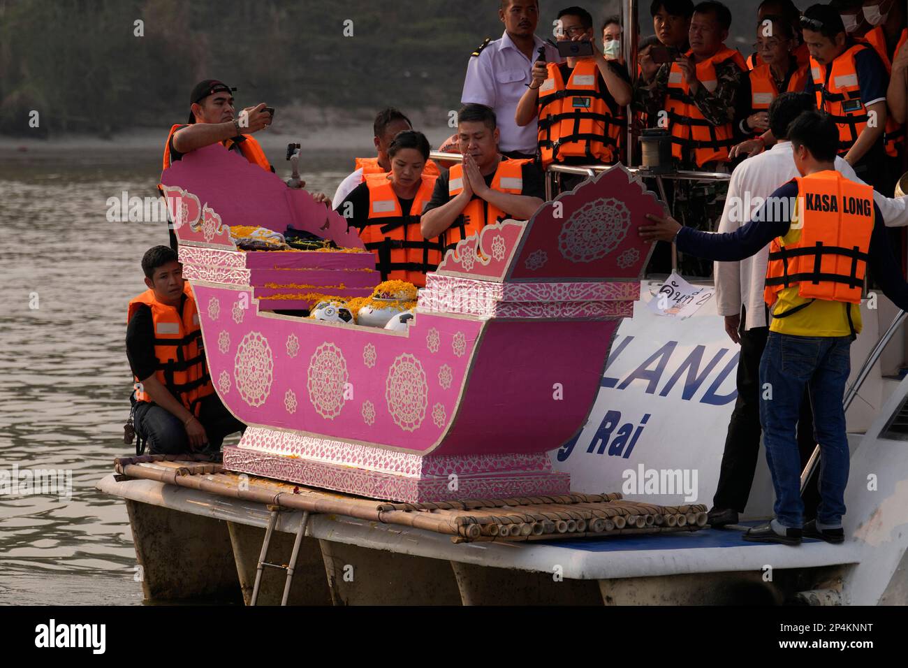 Family members, accompanied fellow mourners, pray before releasing the ...