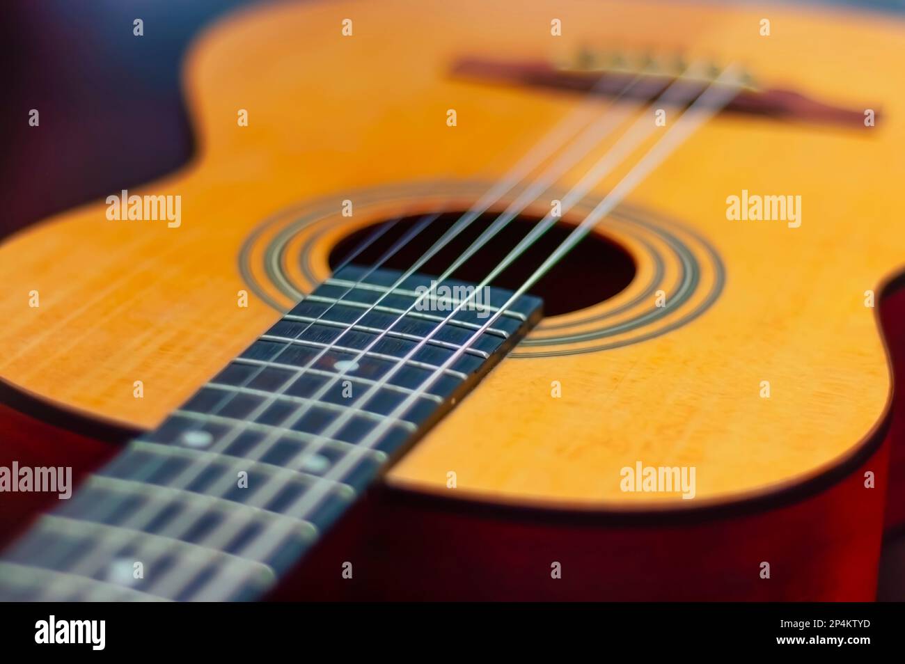 A close up of classical acoustic guitar with nylon strings, lying on a ...