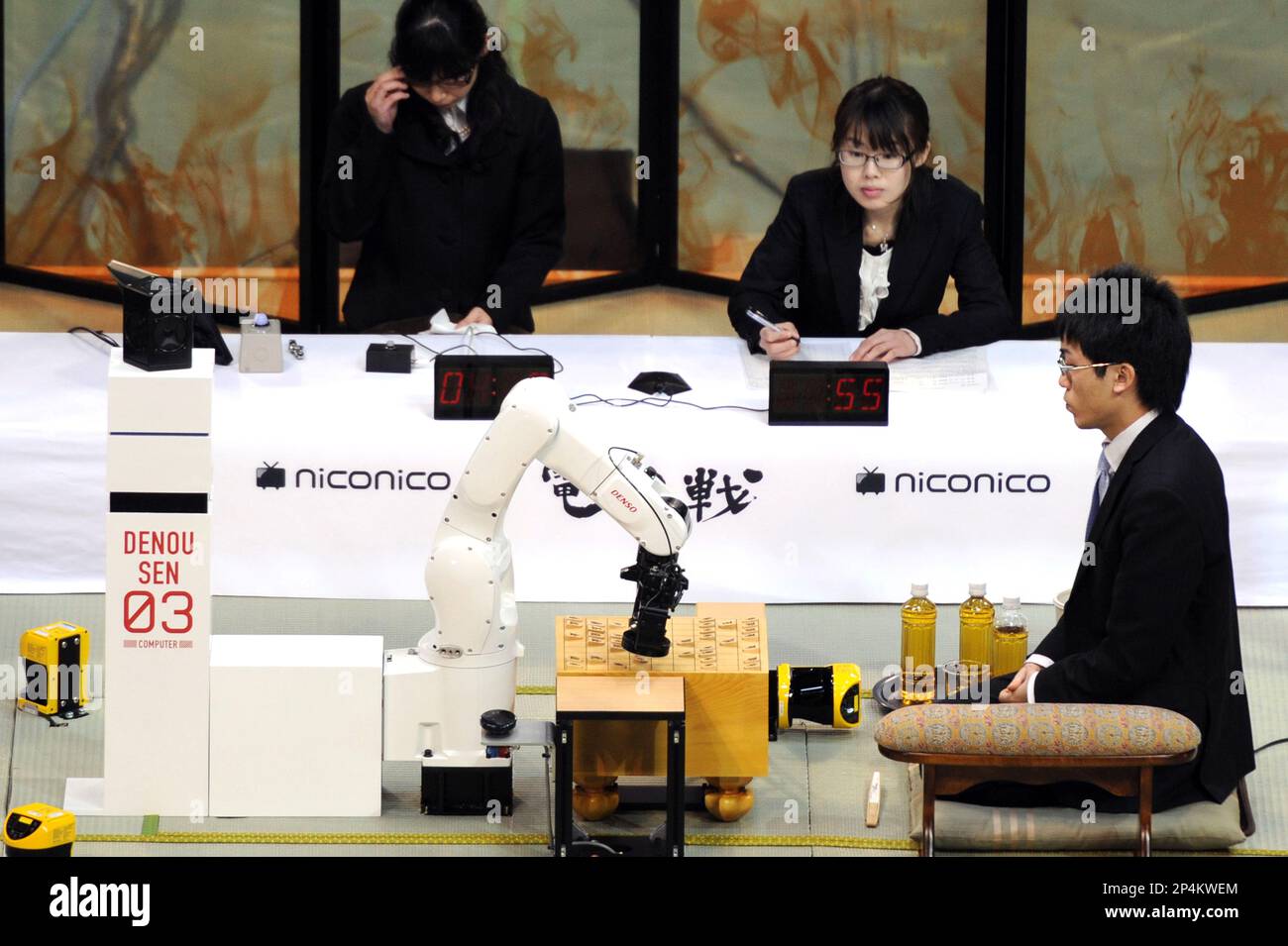 A shogi (Japanese chess) playing robot arm faces a professional player ...