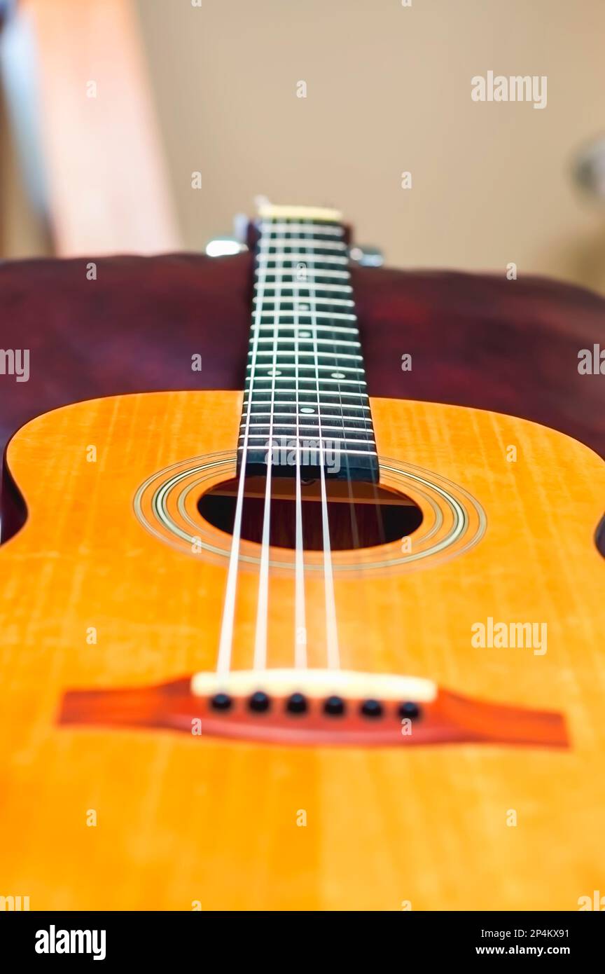 A close up of classical acoustic guitar with nylon strings, lying on a ...