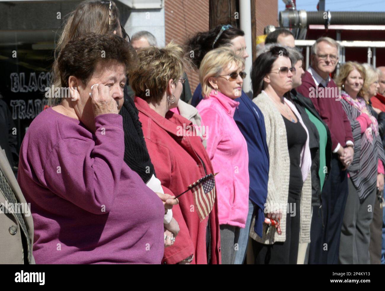 Martha Searcy wipes a tear from her eye as the body of slain U.S ...