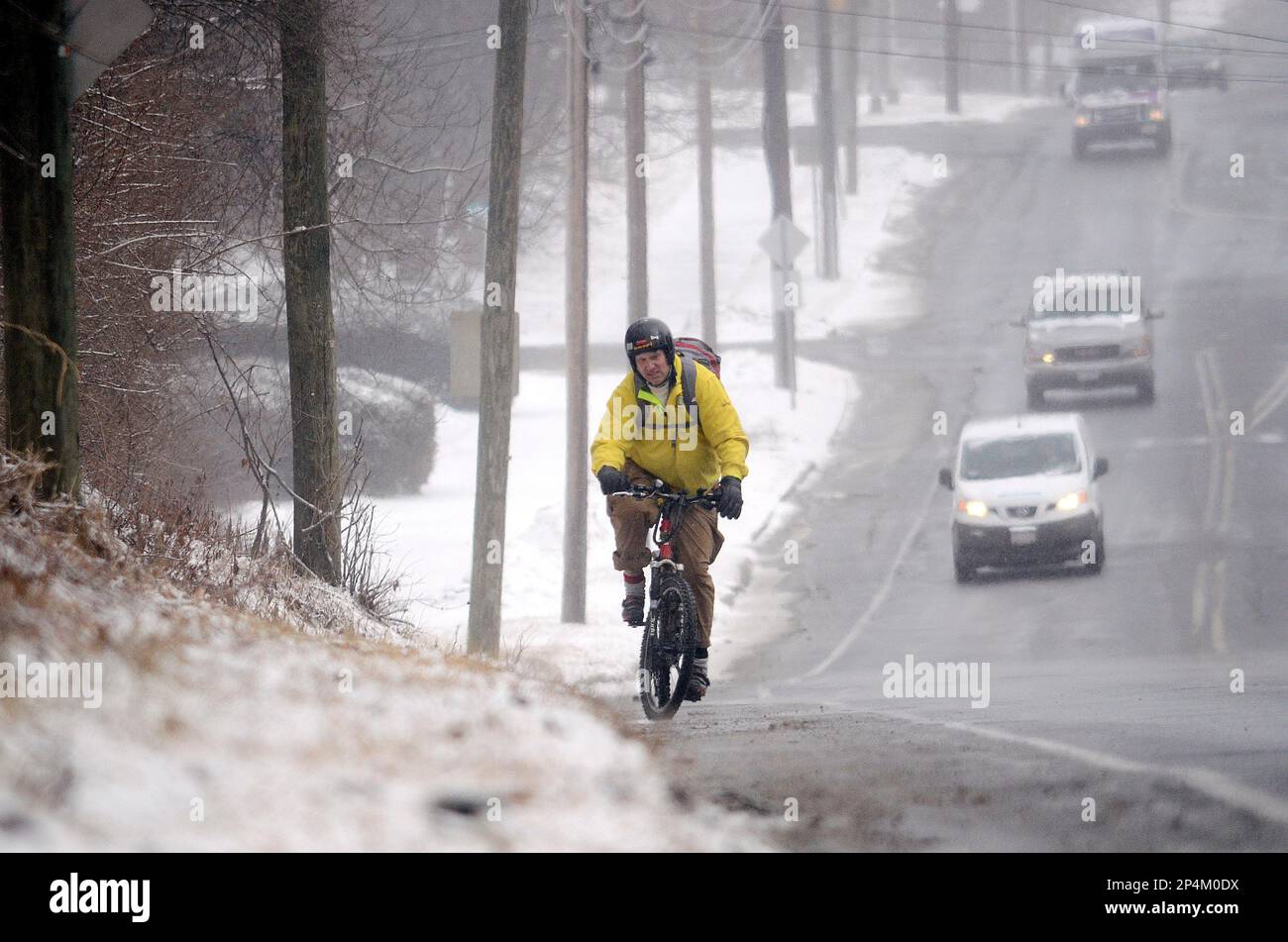 Damon Fleischer struggles uphill through the wintry mix on West Street ...