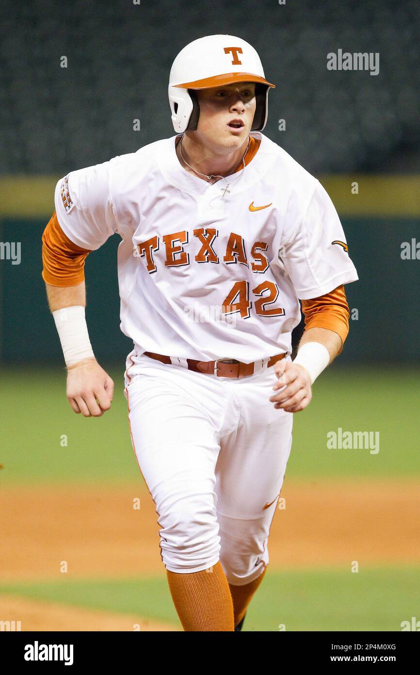 Kacy Clemens #42 of the Texas Longhorns hustles towards third base ...