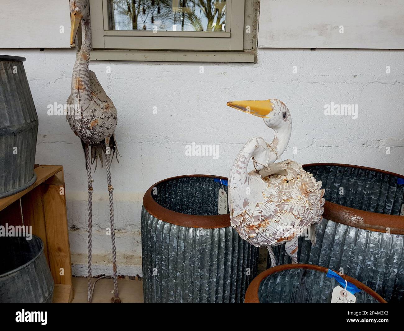A decorative display of metal pots and ornamental storks Stock Photo ...
