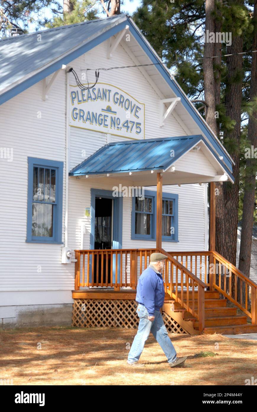 Grange member Bob Messinger tidies up the grounds around the old ...