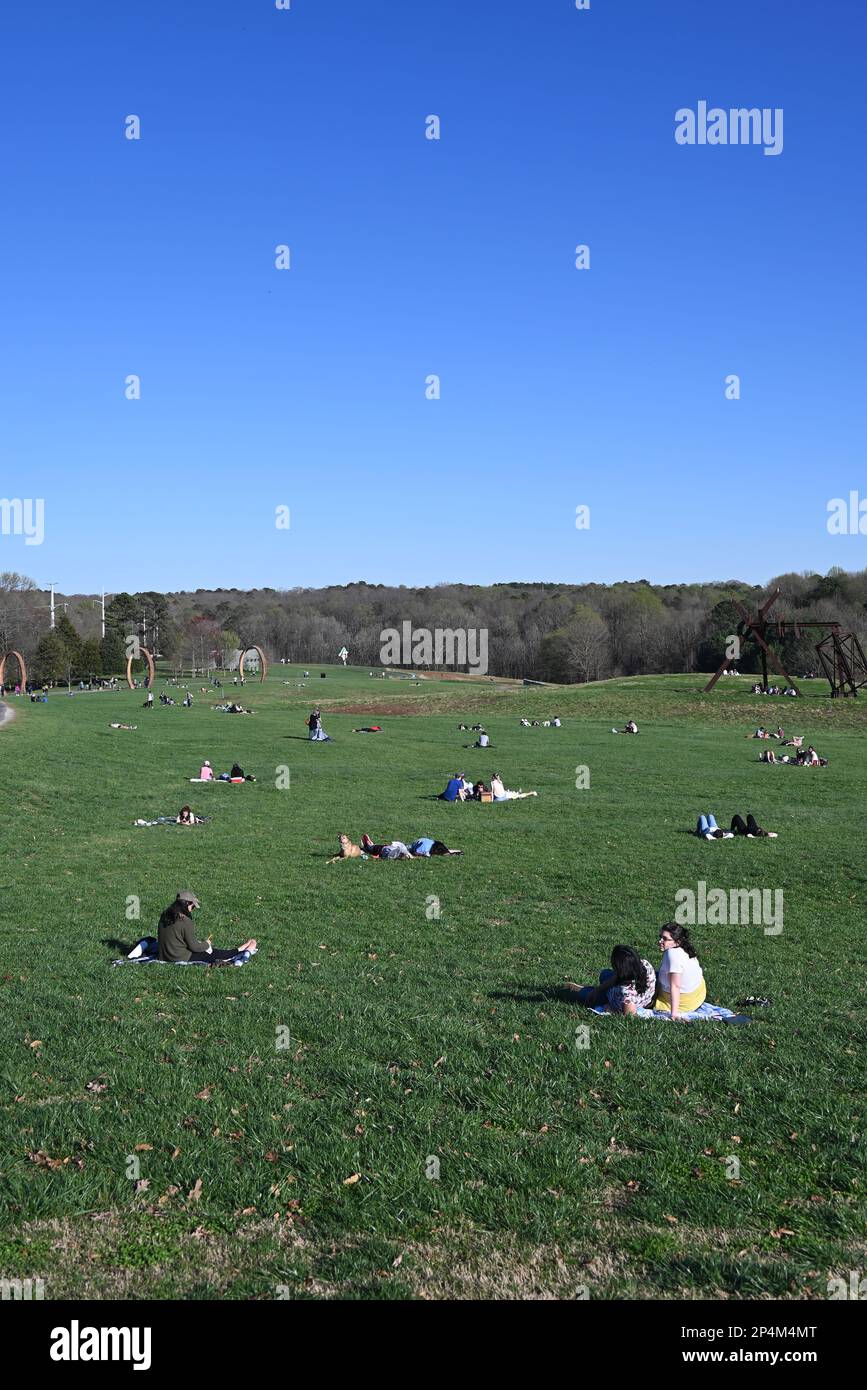 People sitting out on the lawn enjoying a warm spring day at the NCMA ...