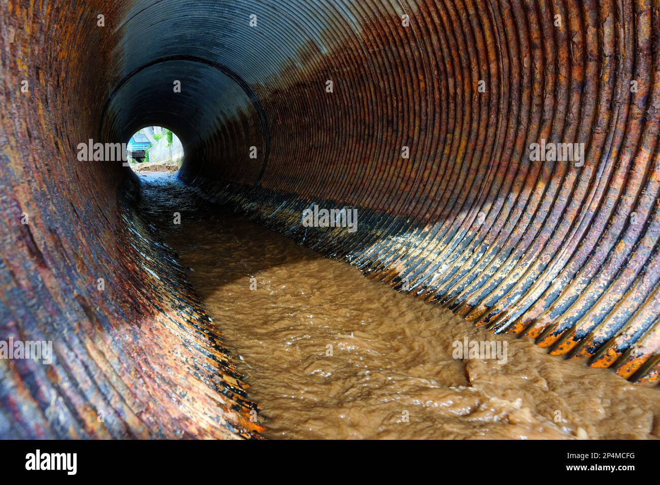 Wastewater running inside a large rusty drainage pipe in Malibu ...