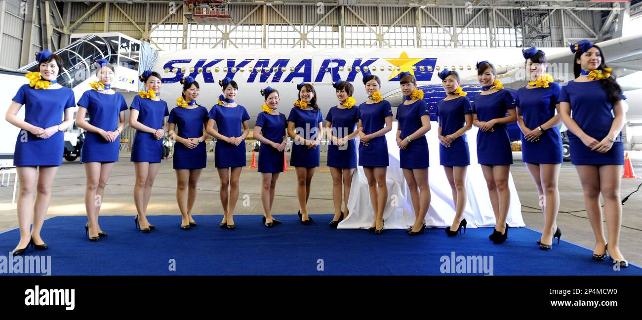 Skymark's cabiin crews, wearing a new unform, pose for a photograph in ...