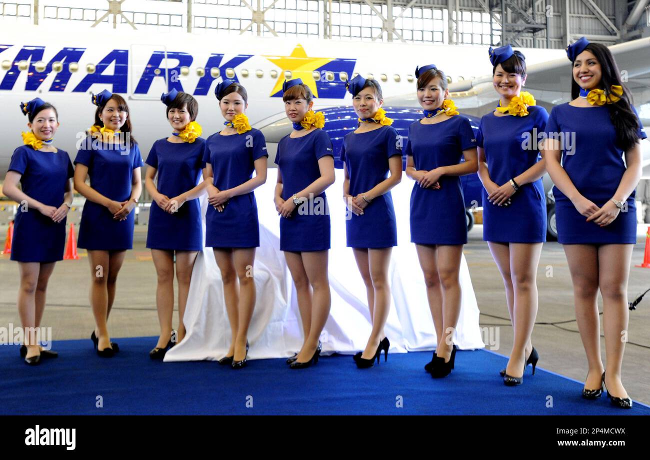 Skymark's cabiin crews, wearing a new unform, pose for a photograph in ...