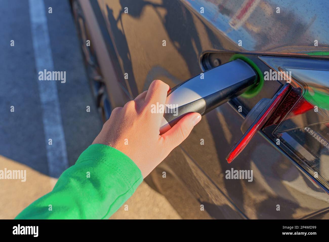 Detailed view of the charging process with a close-up shot of a hand ...