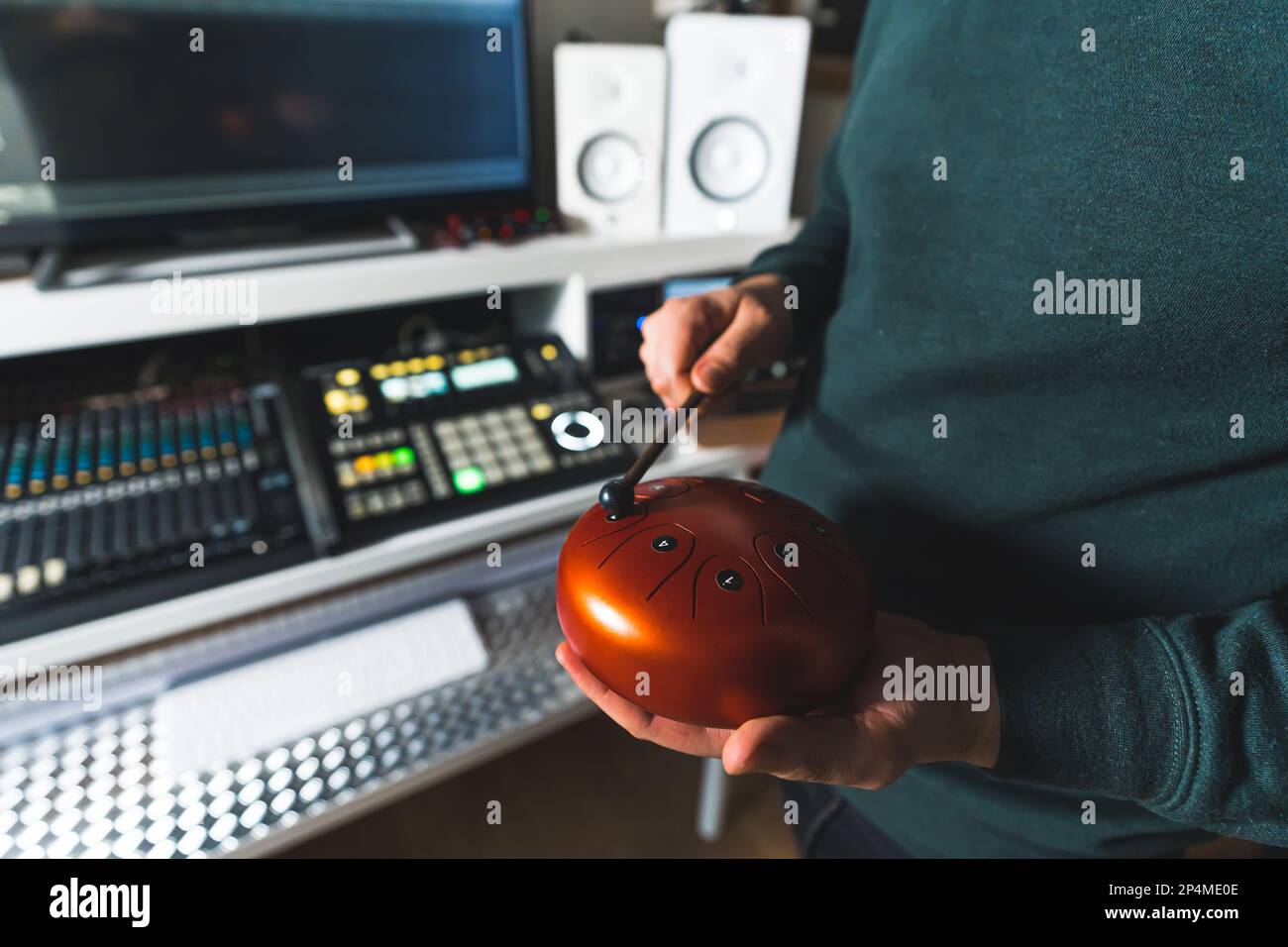 young musician man holding a happy steel drum in front of his musical ...