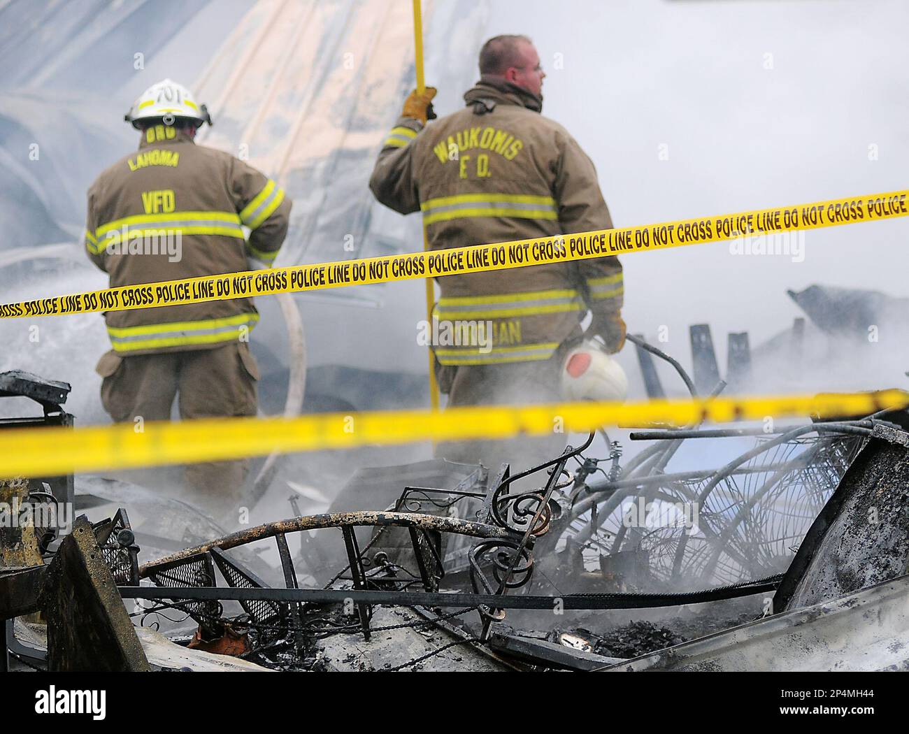 Police crime scene tape surrounds the location of a fatal house fire ...