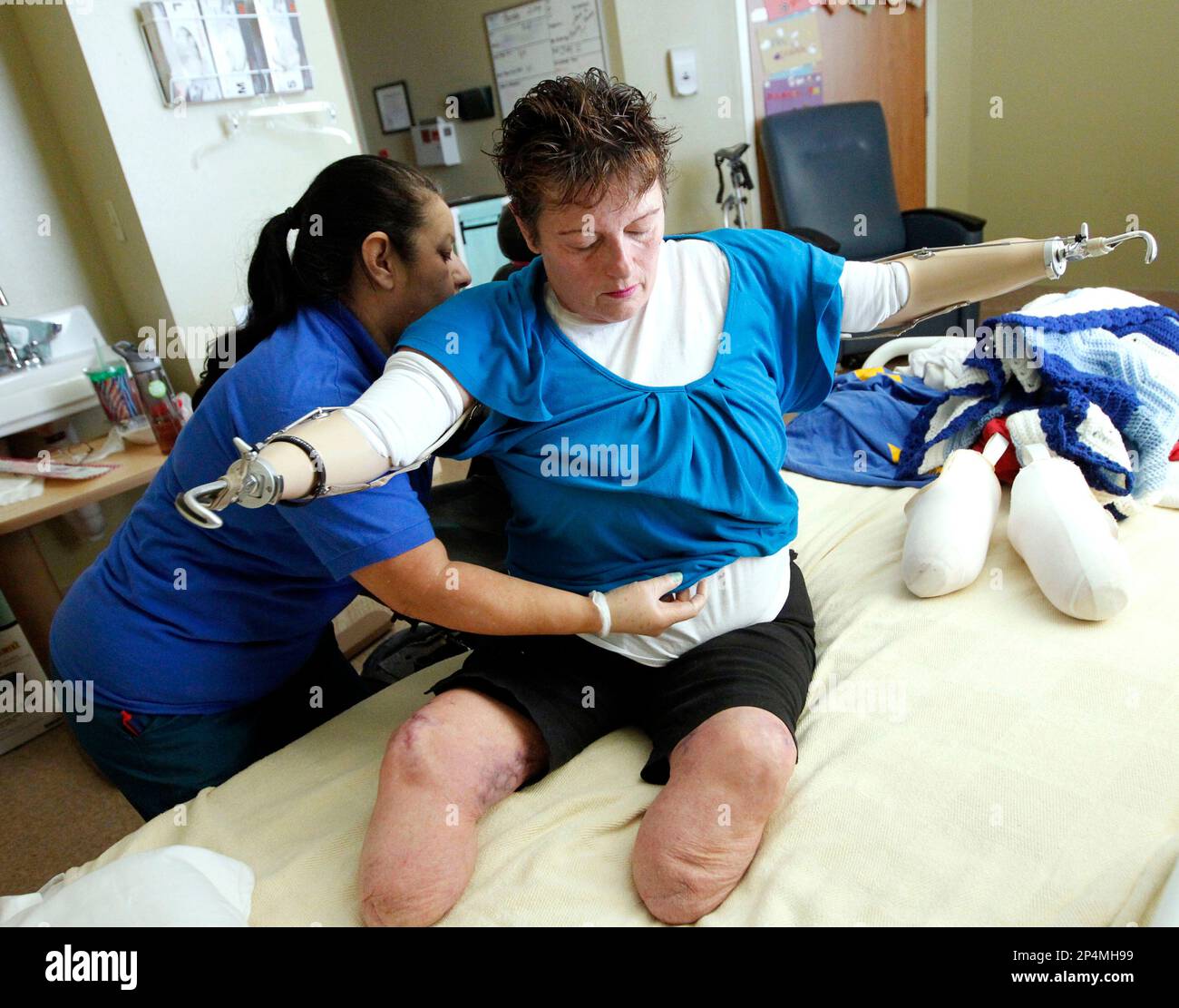 This photo taken Feb. 14, 2014, shows Donna Lowery, right, getting help ...