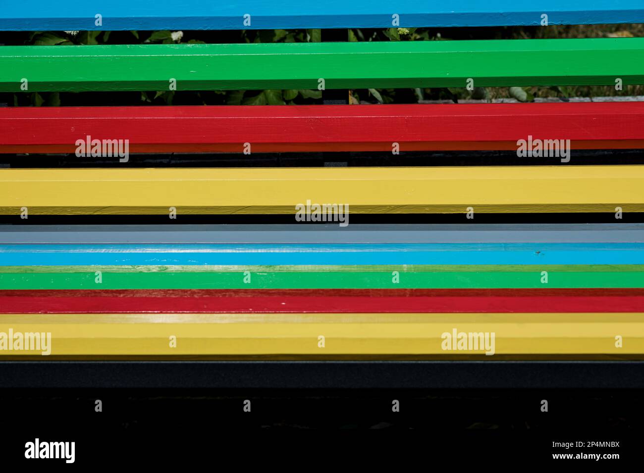 colorful bench in the city park is made in the form of colored pencils ...