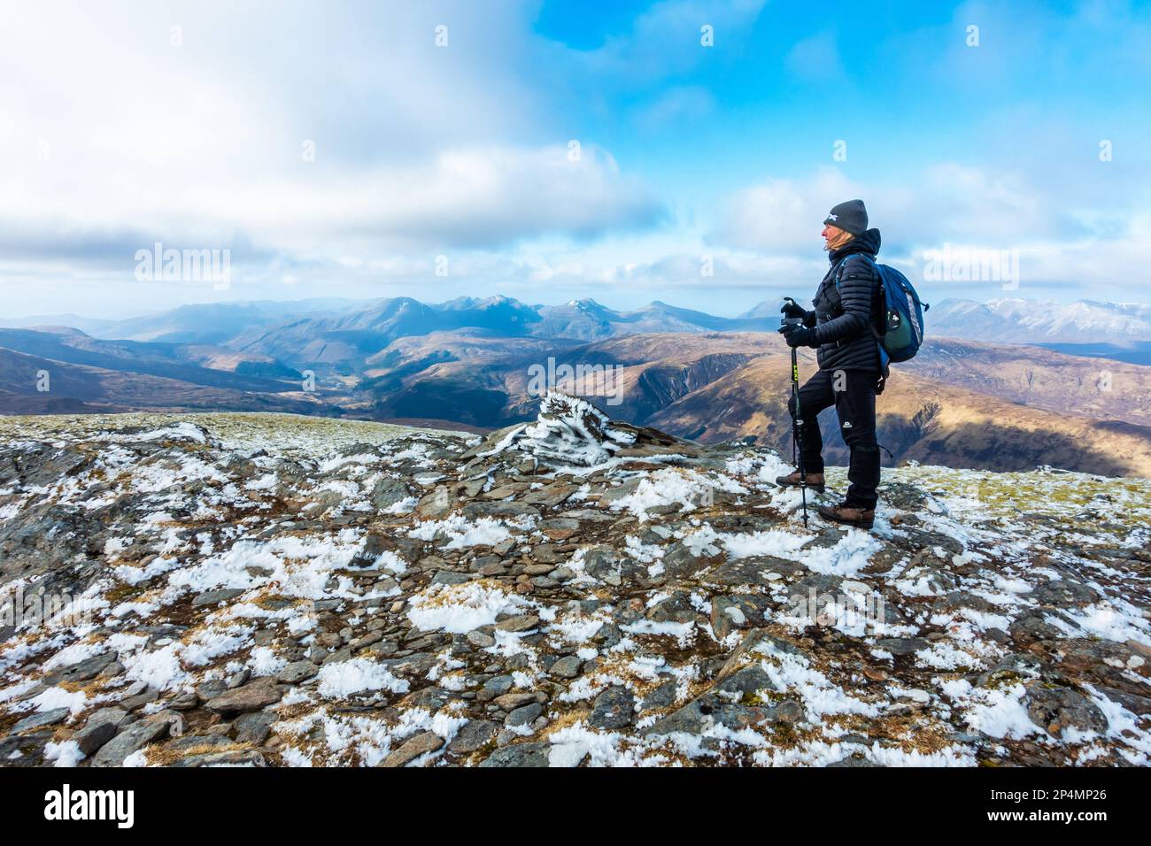 A walker near the summit of the scottish Munro mountain of Moruisg ...