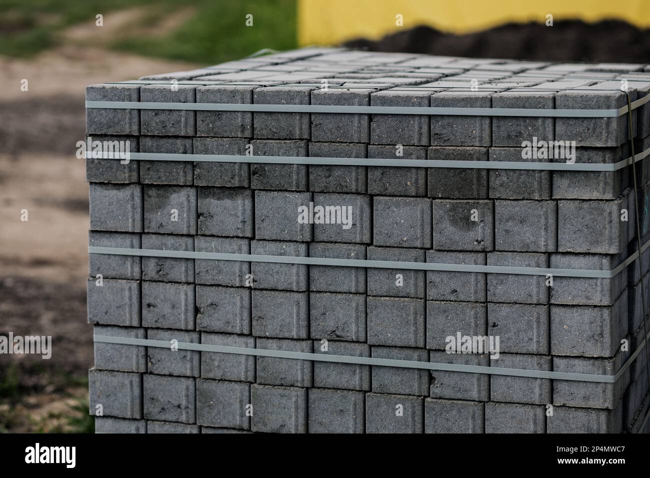 cement paving stones stacked at construction site. Pile of new paving ...