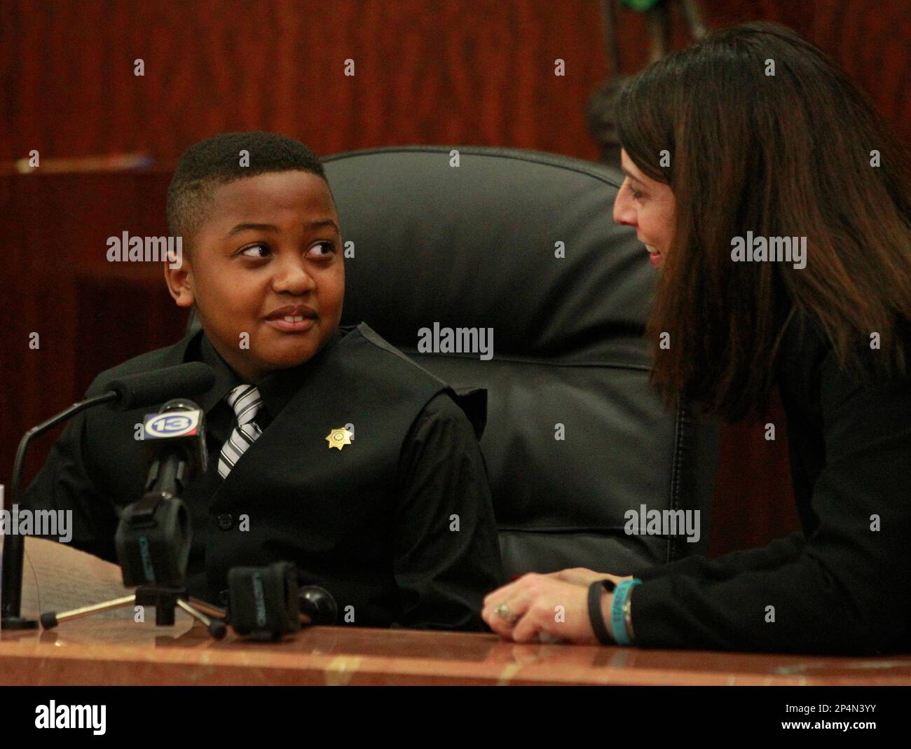 Christian Polk, 11, is seated on the stand by attorney Alison ...