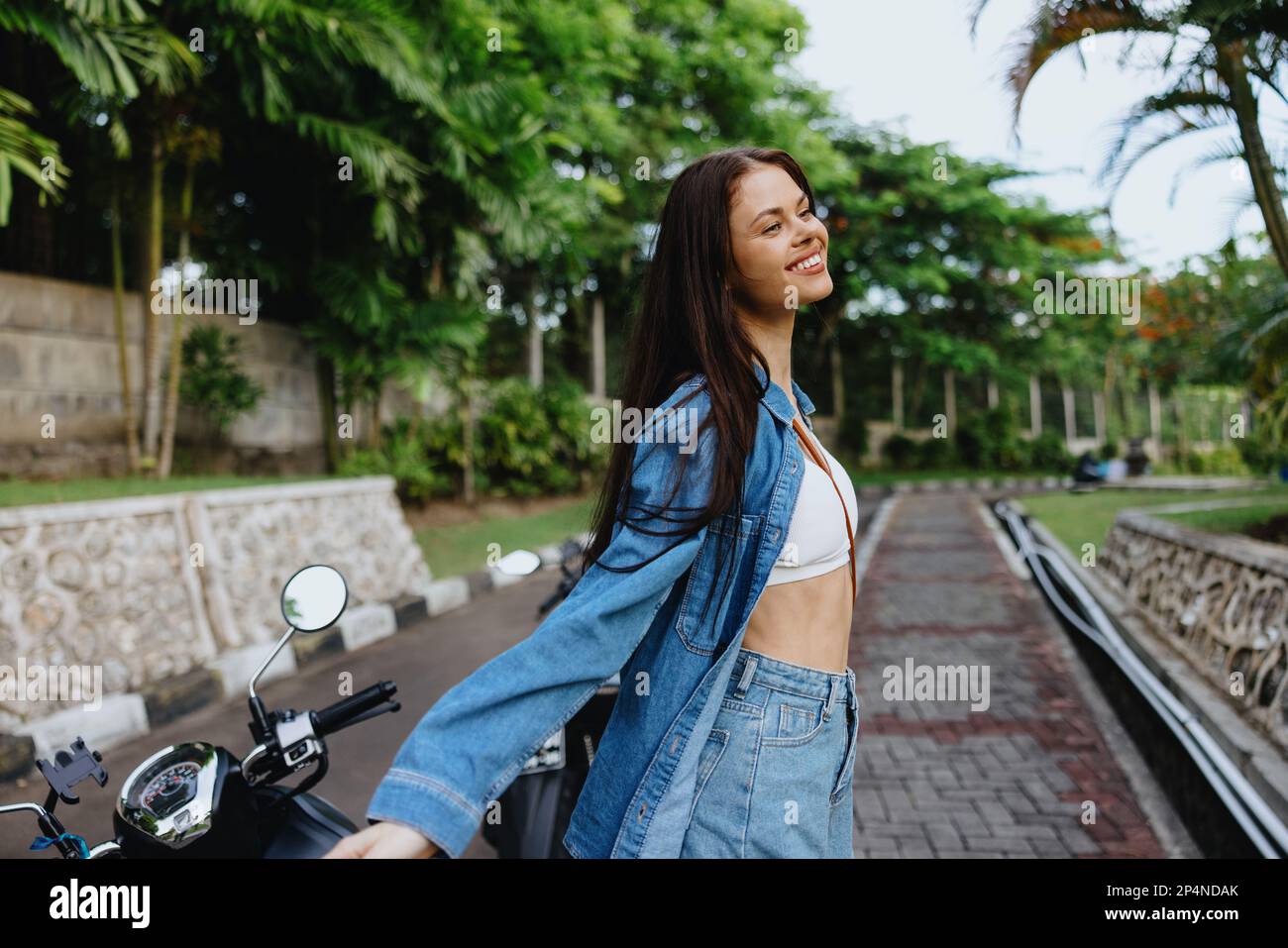 Portrait of a woman brunette smile with teeth walking outside against a ...