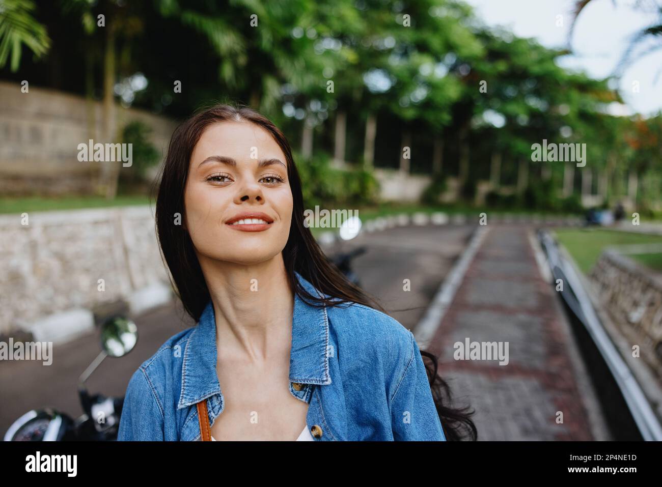 Portrait of a woman brunette smile with teeth walking outside against a ...